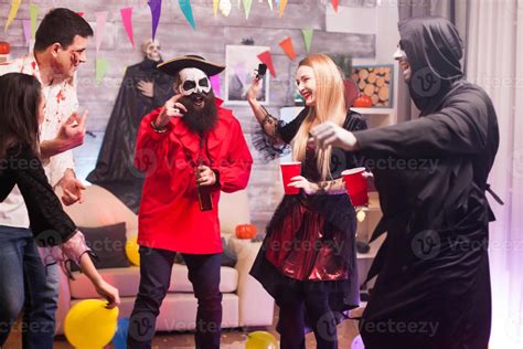 Grim Reaper And Pirate Dancing While Celebrating Halloween Spooky Costumes 35234493 Stock
