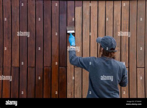 Handy Woman Improving House Hardwood Cladding With Wood Stain Application Do It Yourself Handy Woman Improving House Hardwood Cladding With Wood Stain Application Do It Yourself