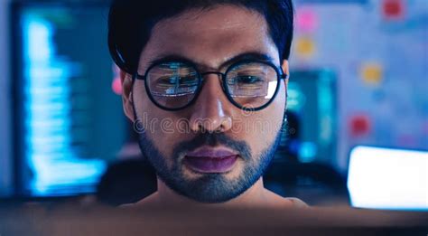 Close Up Of A Programmer Intensely Focused On His Work With Computer