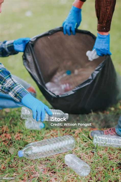 Man Collecting Garbage Volunteer To Collect Plastic Bottles In Black