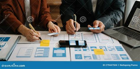 Ux Developer And Ui Designer Brainstorming About Mobile App Interface Wireframe Design With