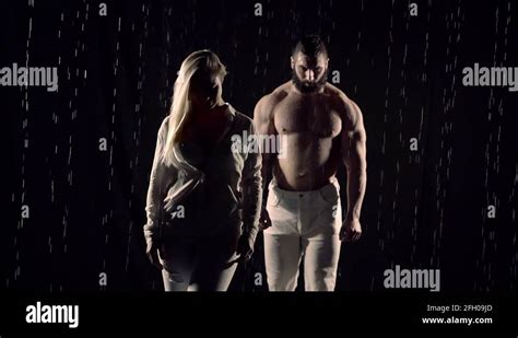 A Naked Man With Huge Muscles Approaches A Woman During A Falling Rain Stock Video Footage Alamy