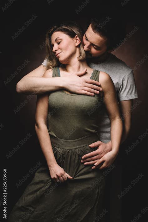 Young Couple Man And Woman Hugging A Man Stands Back And Hugs Her
