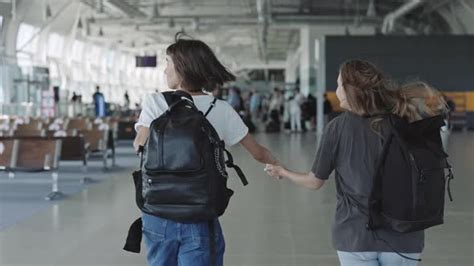 Happy Lesbians Holding Hands And Running At Airport Stock Footage