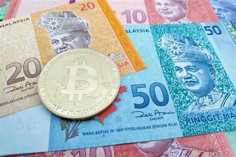 Premium Photo Bitcoin On Top Of A Stack Of Malaysian Ringgit Banknotes
