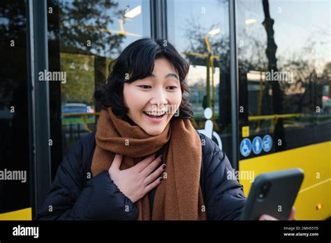 Portrait Of Cheerful Asian Girl Talks On Mobile Phone Video Chats