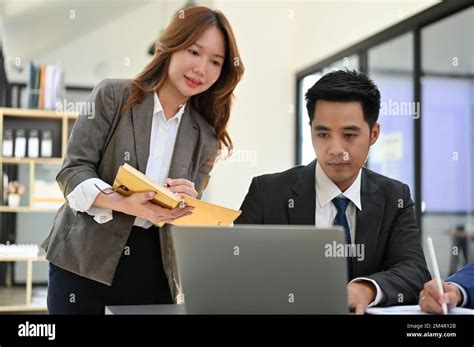 Attractive Young Asian Female Secretary Or Assistant Working With Her