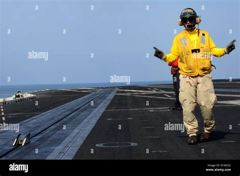 A Shooter Catapultarresting Gear Officer Signals For The Launch Of