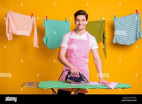 Photo Of Young Happy Cheerful Positive Good Mood Man Ironing Clothes On