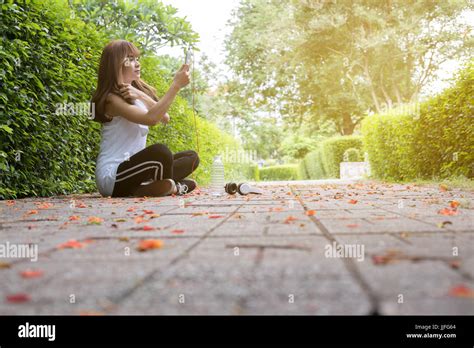 Asian Woman With Headphones Young Female Holding Mobile Smart Phone