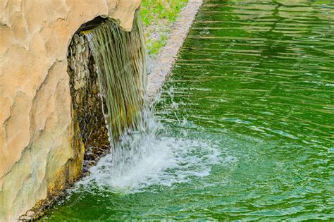 Premium Photo Small Artificial Waterfall In Man Made Tropical Garden