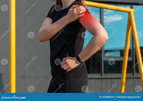 Athlete Touching Painful Shoulder With Red Point During Outdoor