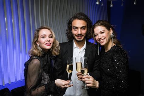Premium Photo Young Man In Suit Standing Between Two Beautiful Girls