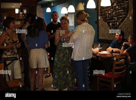 Members Of The Conversational Club Are Seen In A Classroom Doing Conversational Exercises The