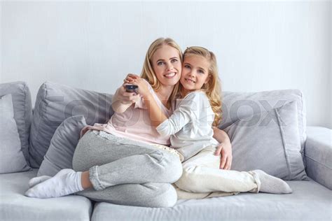 Mother And Daughter Watchng Tv Together On Couch Stock Image Colourbox
