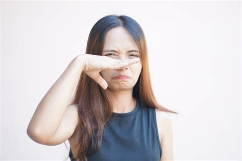 Premium Photo Asian Woman Covering Her Nose With Her Hands Due To A