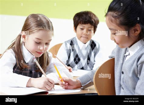 Students Helping Each Other In A Classroom Stock Photo Alamy
