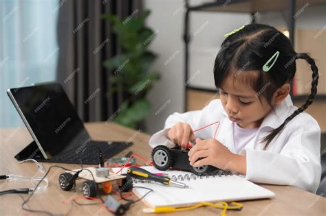 Premium Photo Asian Littlle Girl Constructing And Coding Robot At Stem Classfixing And Repair