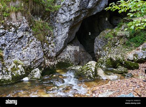 River Flowing Into A Cave In A Karst System In The Limestone Mountains