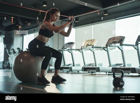 Sporty Woman Doing Workout And Using Fitball By Sitting And Balancing