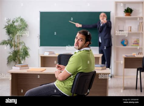 Aged Male Teacher And Lazy Babe In The Classroom Stock Photo Alamy