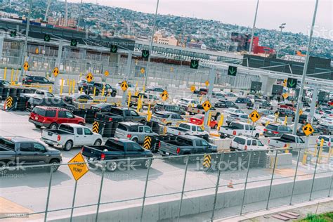 High Angle Telephoto View Of Cars Crossing The Usmexico Border At