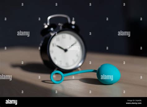 Alarm Clock And Vibrator On The Table Time For Training Intimate Muscles Vaginal Balls