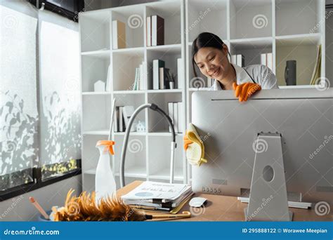 Woman Maid Cleaning And Wiping The Computer With Microfiber Cloth In