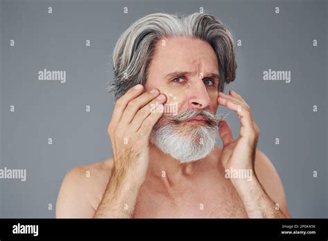 Taking Care Of Skin Stylish Modern Senior Man With Gray Hair And Beard