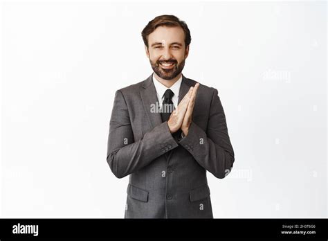 Image Of Pleased Handsome Businessman Rubbing His Hands Smiling
