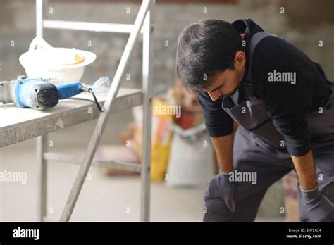 Exhausted Construction Worker Resting In A House Under Renovation Stock