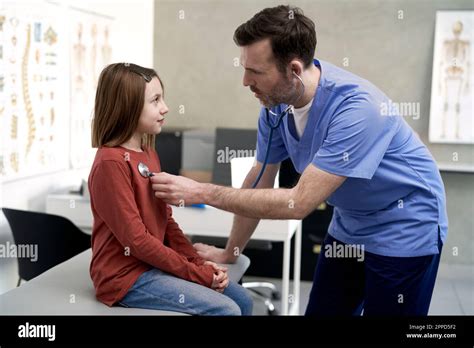 Mature Doctor Examining Girl In Clinic Stock Photo Alamy