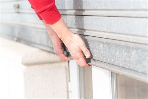 Man S Hand Closing Metal Roller Shutter Door Stock Photo Image Of