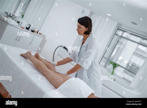 Woman Enjoying Procedure Of Legs Massage In Spa Salon Beauty Concept
