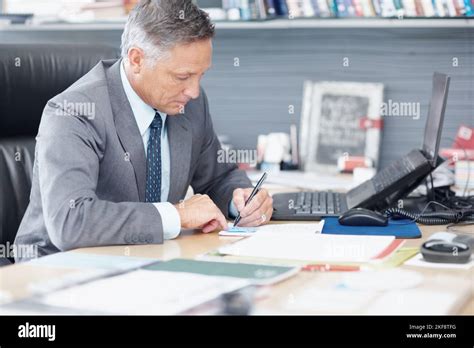 Scheduling His Day To Maximise His Time A Senior Businessman Working Hard At His Desk Stock