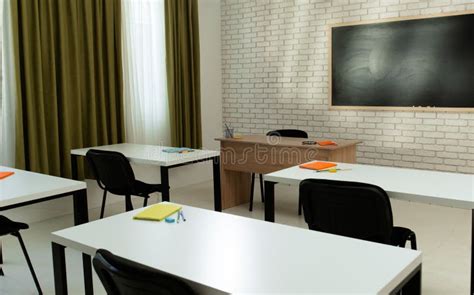 Empty Modern School Classroom With Desks Chairs And Chalkboard At