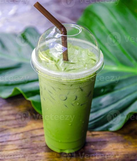 Iced Matcha Latte Green Tea With Milk In A Plastic Glass With Ice