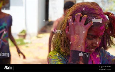 Beautiful Young Girl Posing With Exploding Pink And Yellow Holi Powder