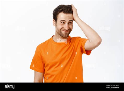 Portrait Of Confused Man Scratching Head And Looking Complicated