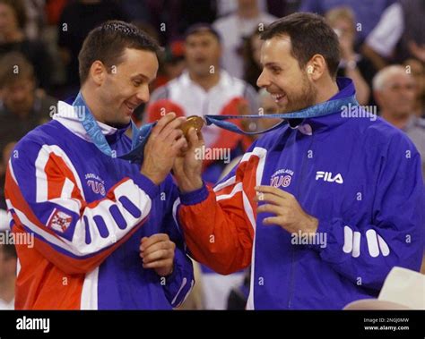 Vladimir Batez Left Clinks Gold Medals With Teammate Goran Vujevic Right During The Medal