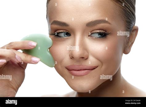 Spa And Women Beauty Cute Beautiful Woman Massage Face With Jade