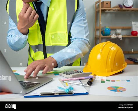 Architect Or Engineer Using Computer To Work On Desk Cost Calculation
