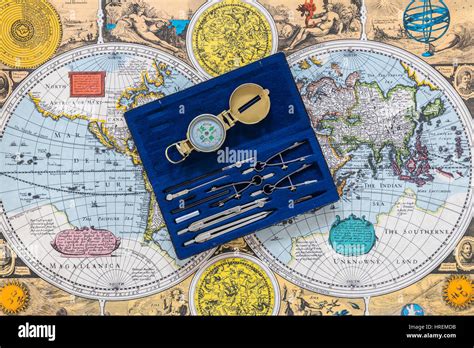 Compass And Antique Drafting Instruments On Ancient World Map Stock