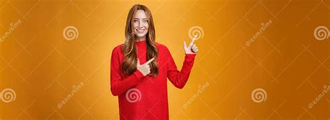 Assertive And Helpful Charming Young Female Assitant In Red Knitted