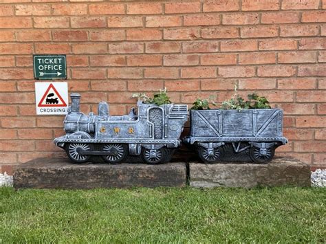 Miniature Train Planter Sits On Short Lengths Of Used Tropical Hardwood