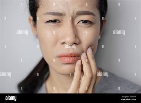 Woman Put Her Hand On Her Cheek Due To Toothache Asian Woman Is