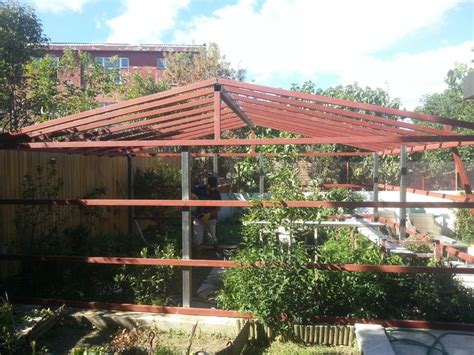 An Outdoor Area With A Wooden Structure And Green Plants