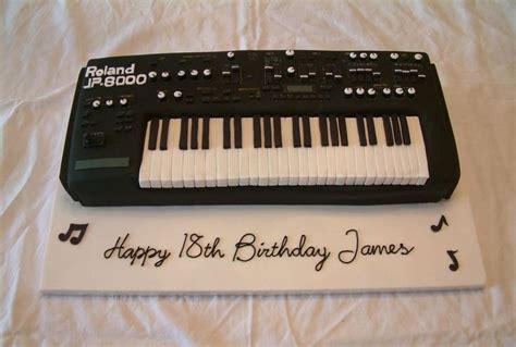 A Birthday Cake With An Electronic Keyboard On It