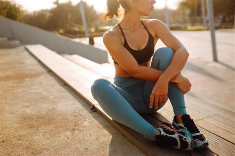 Premium Photo Young Woman In Sports Outfit Doing Exercises Outdoors