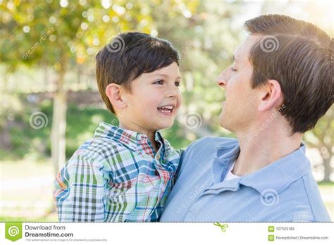Happy Caucasian Father And Son Playing Together In The Park Stock